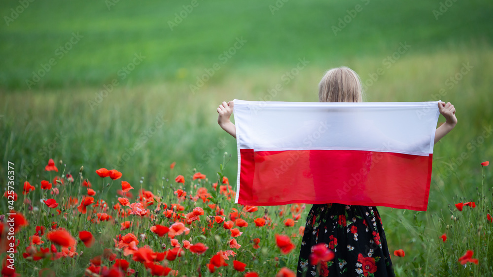 Blond girl holding flag of Poland in the poppy field. Back view. Polish ...