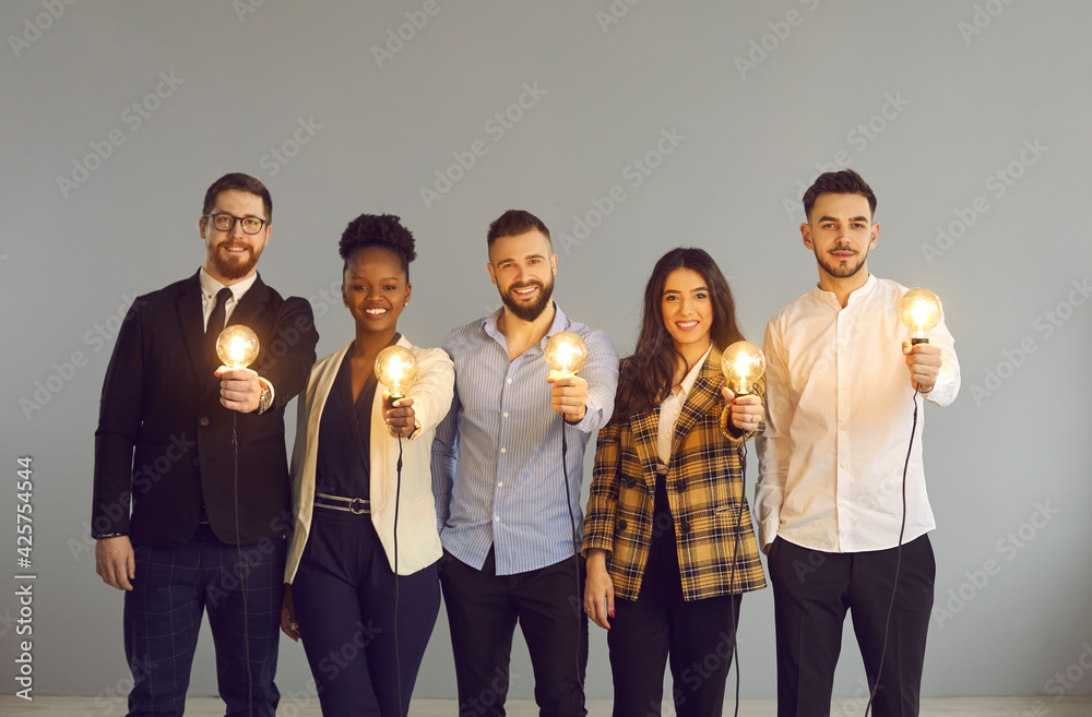 Diverse multinational business team holding light idea bulb show new ...
