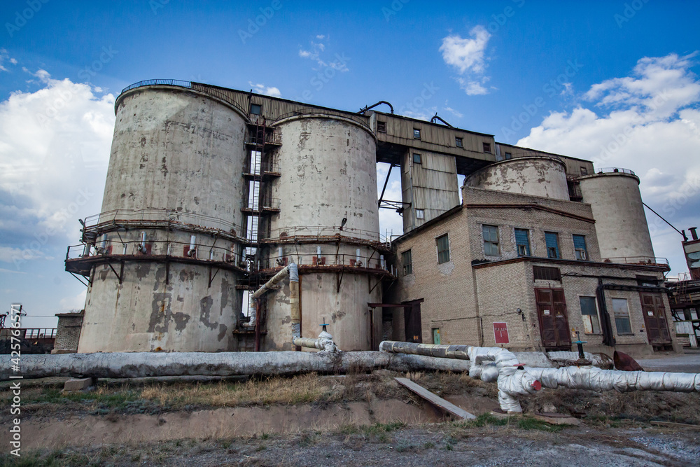 Outdated Soviet mining and processing plant. Concrete storage elevator ...