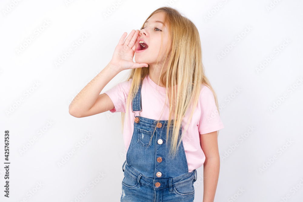 beautiful caucasian little girl wearing denim jeans overall over white ...