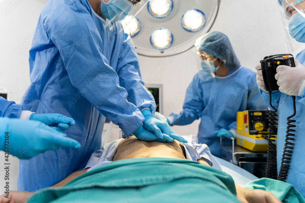 Poster Medical team in Surgical gown help patient to making CPR Cardio ...