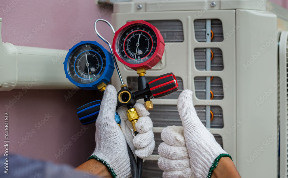Technician man giving thumb up with holding refrigerant manifold gauge ...