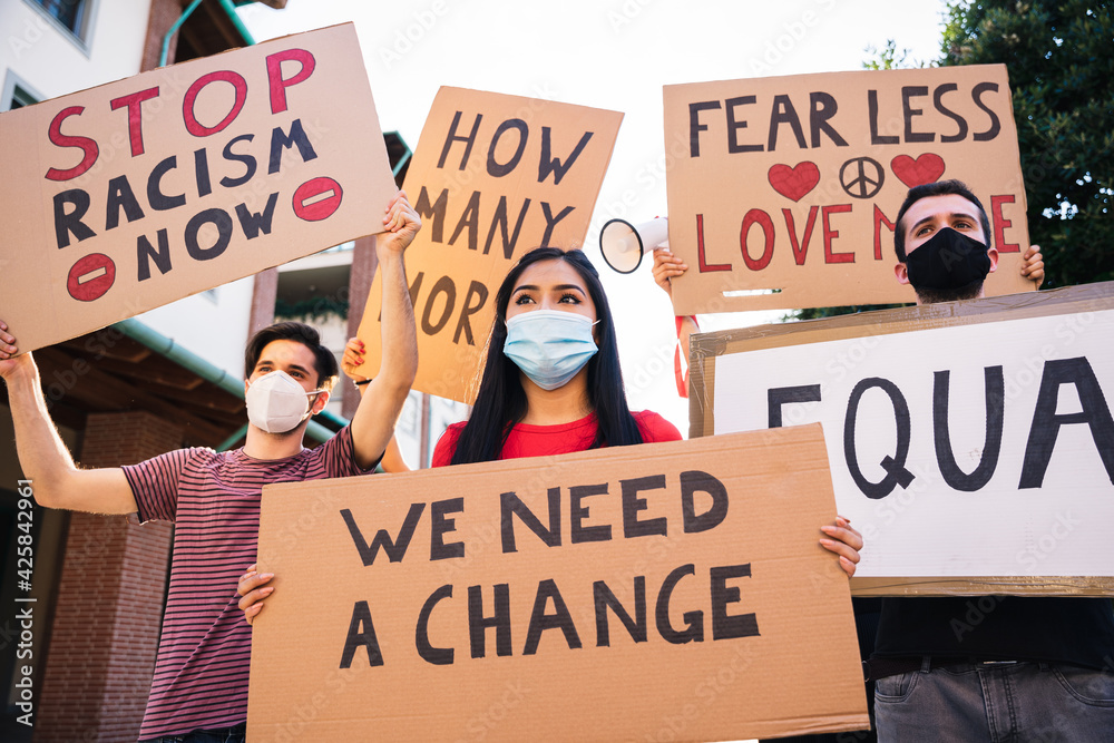 Group of young multiethnic demonstrators in a road - People protesting ...