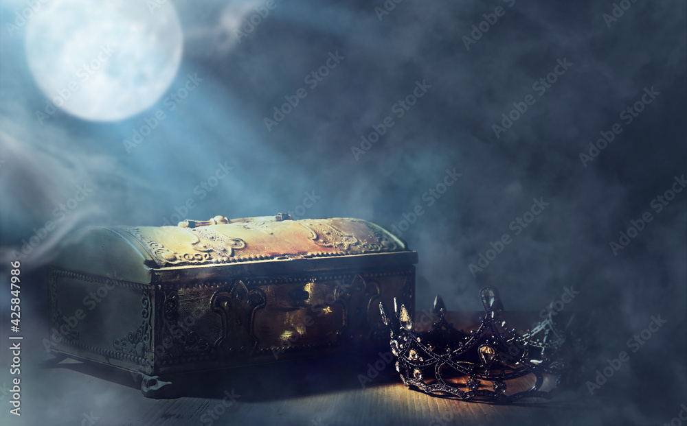 Image of mysterious magical treasure chest with light over wooden old ...