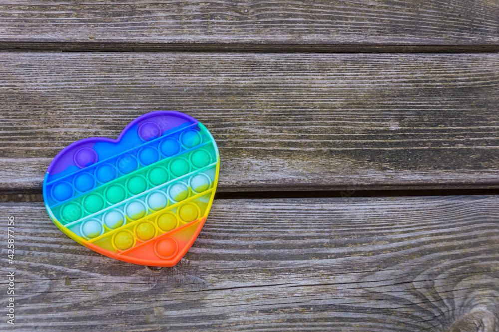 rainbow colored pop it fidget toy on wooden background Stock Photo ...