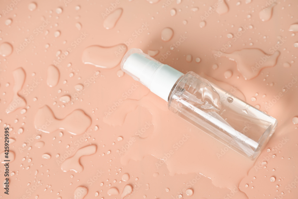 transparent cosmetic gel in a glass bottle with pump. beige background ...