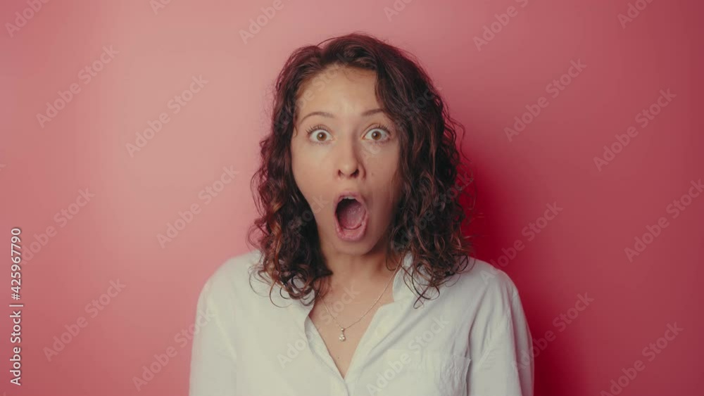 Shocked woman face with opened mouth and eyes looking to camera on a ...