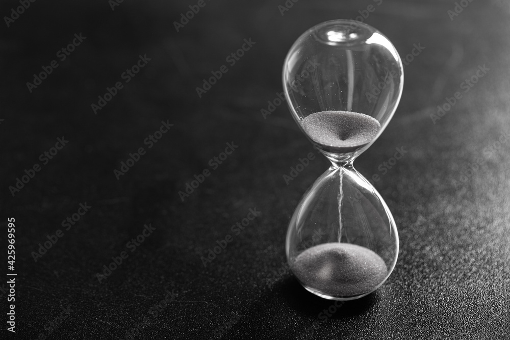 Sand passes through an hourglass measuring the travel time counting ...