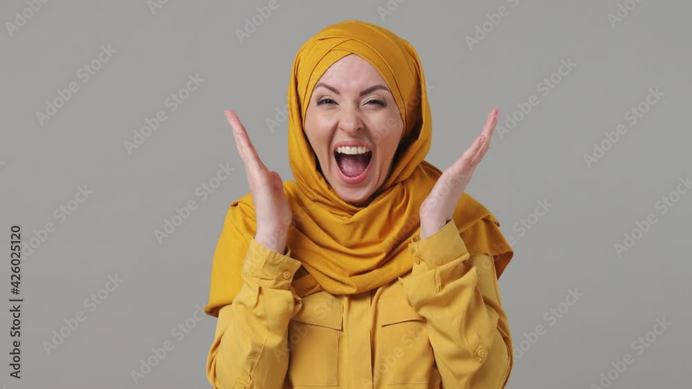 Joyful surprised shocked young arabian asian muslim woman in abaya ...