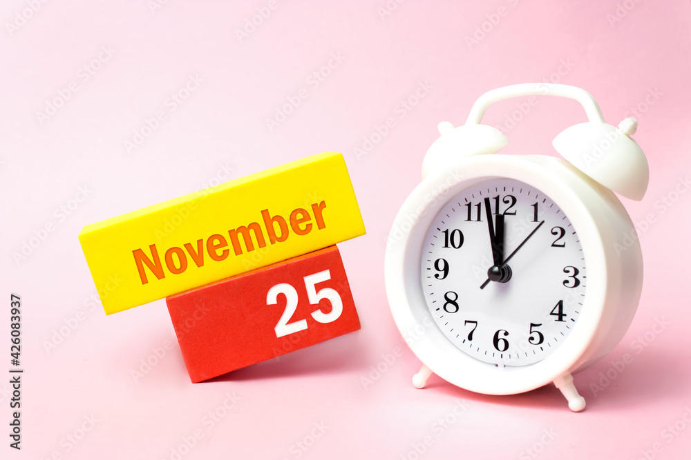 November 25th. Day 25 of month, Calendar date.White alarm clock on ...