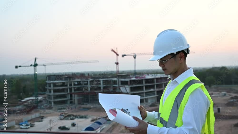 Construction engineers looking at the construction drawings from the ...