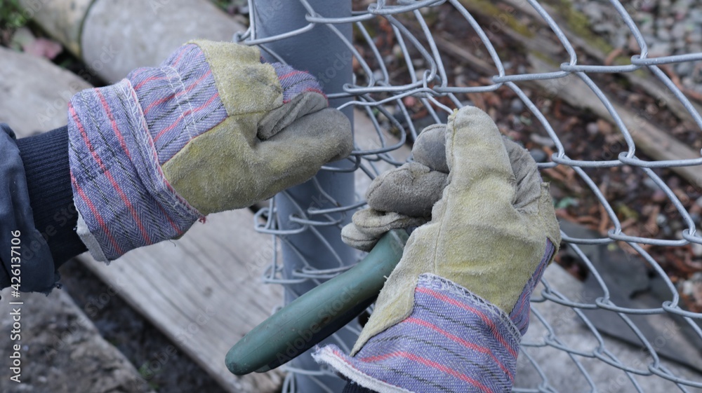 fixing the galvanized mesh to the base of the post when installing the ...