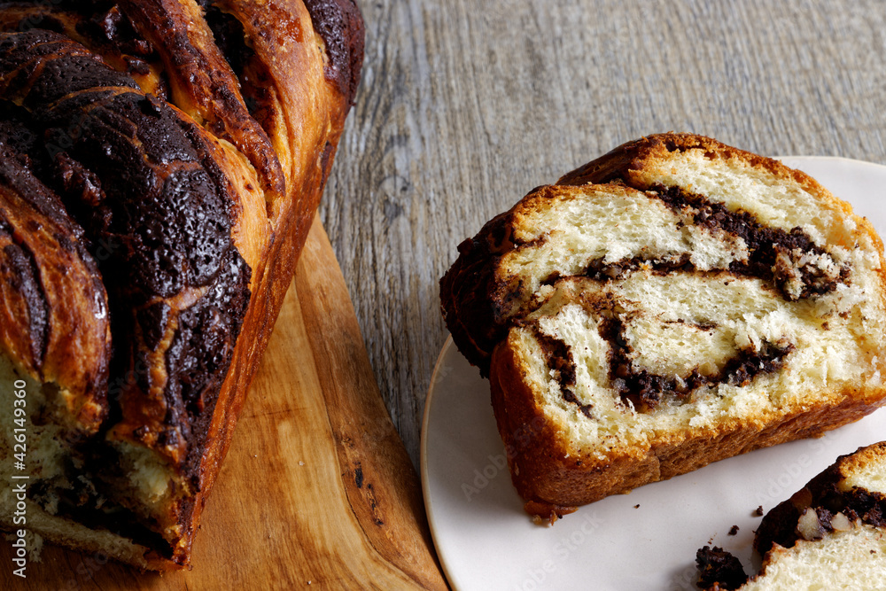 Cut piece of Krantz cake with chocolate and nuts filling. Yeast-risen ...