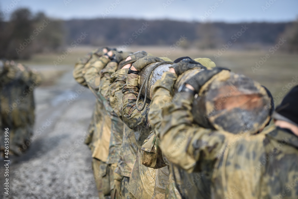 Special forces military training carrying a big log. Photograph detail ...