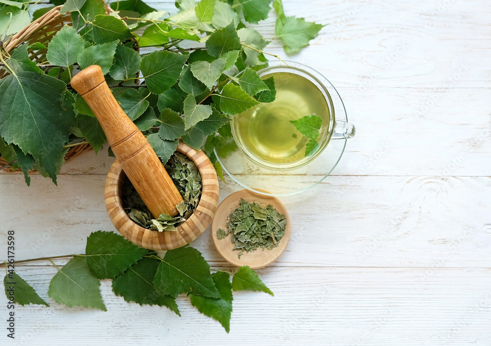 Pestle and Mortar with powdered birch leaves, fresh Detox birch tea in ...