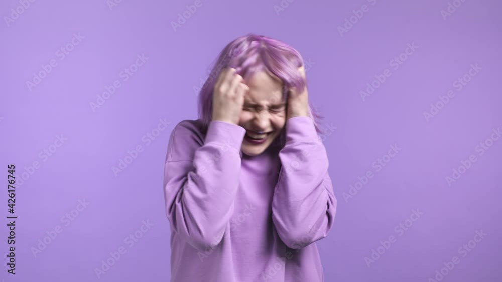 Frightened and screaming woman with dyed purple hair shocked isolated ...