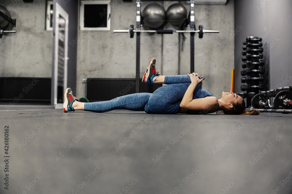 Stretching the leg muscles. An elastic woman in good physical shape ...