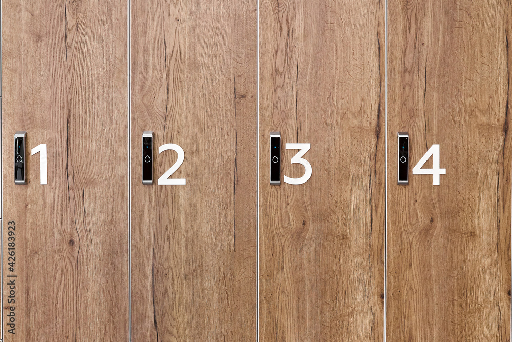 Modern dressing room in the gym. Wooden lockers for clothes with ...