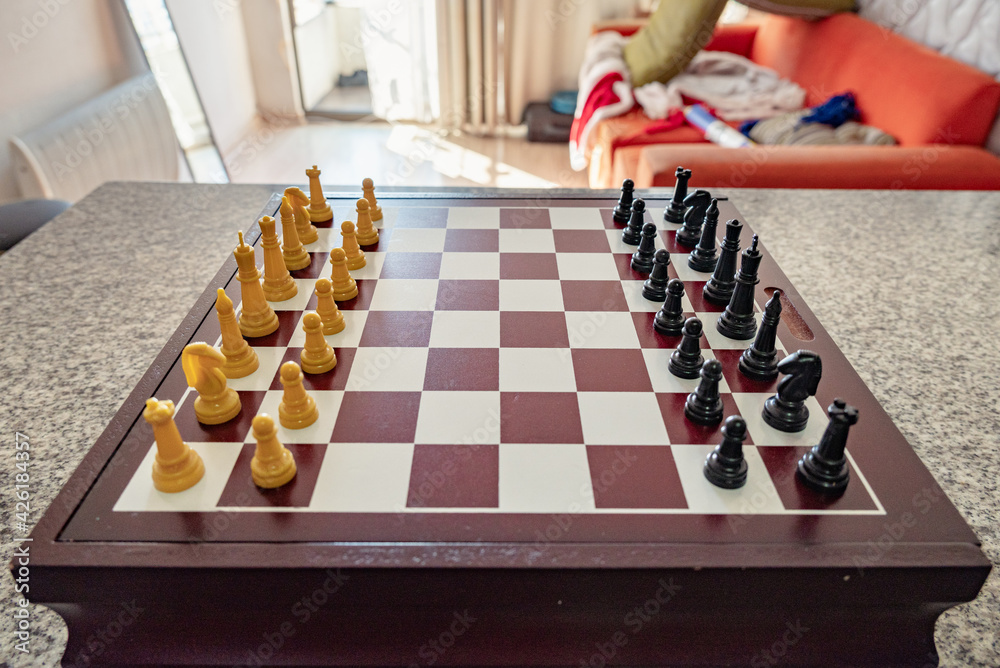 Side angle view of a chess board with inicial pieces arrangement and ...