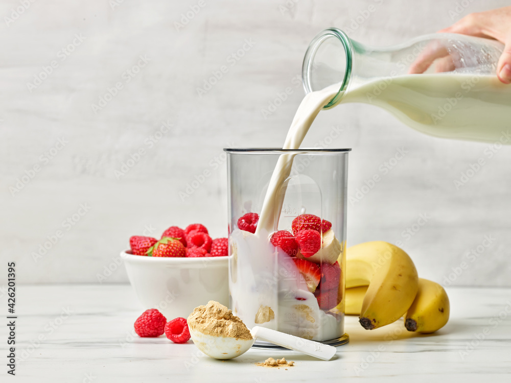 fresh milk pouring into blender container Stock Photo | Adobe Stock