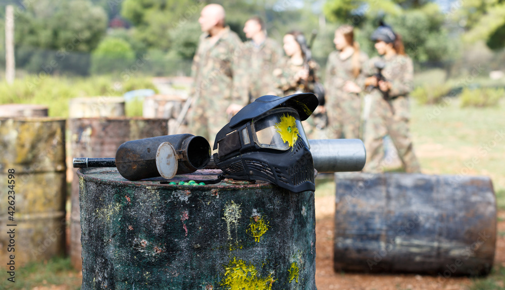 Paintball mask with splash after direct hit from marker gun lying on ...