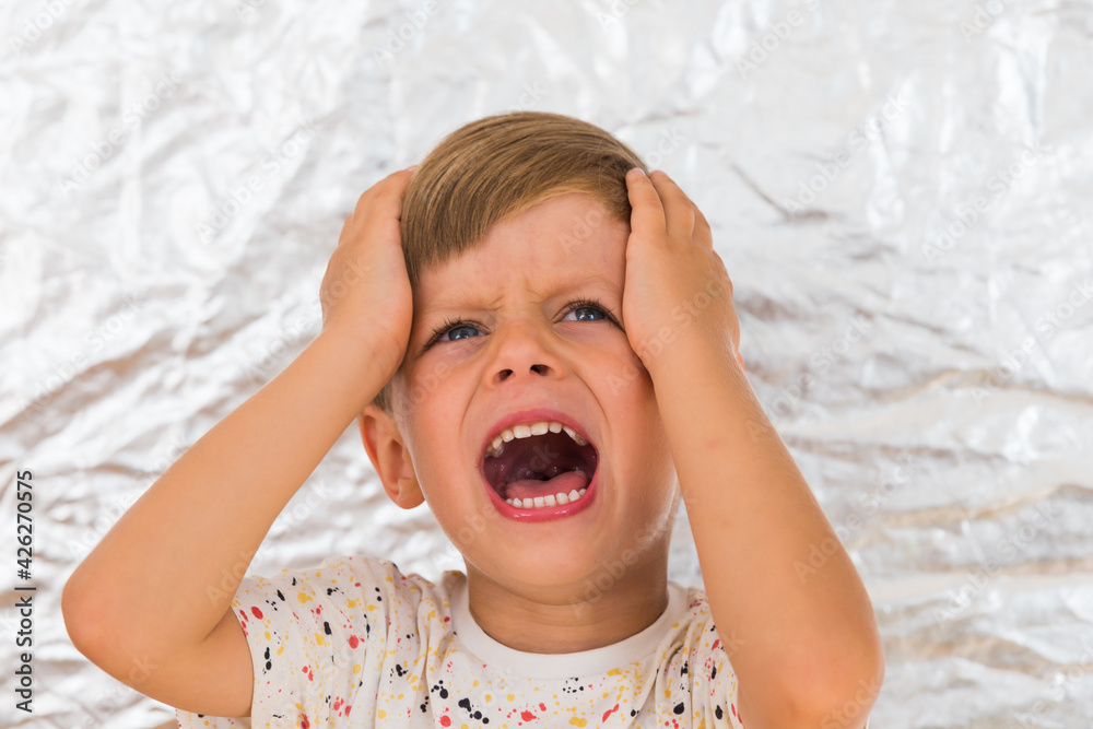 Cute blond boy. Shows different emotions. Head pain. Headache. Real ...