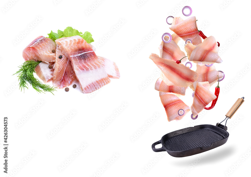A steak of flying fish falls into the pan. The effect of flying motion ...