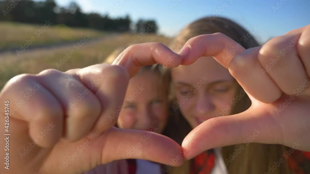 kids hands shape of heart,symbol of love.Smiling positive faces of ...