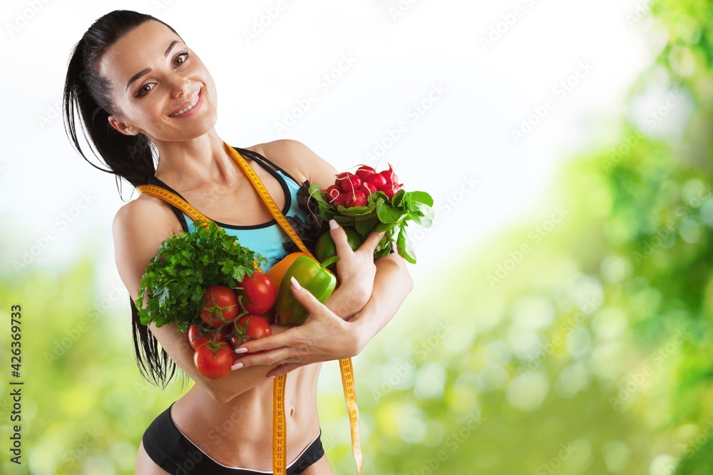 Beautiful slim female body with fresh vegetables Stock Photo | Adobe Stock