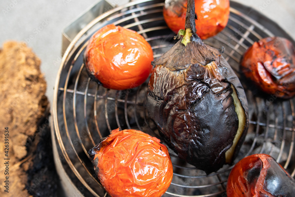 Cooking Baingan Ka Bharta With Roasted Brinjal Or Eggplant And Tomatoes ...