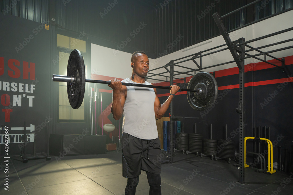 Black African American man lifting sport bar. Muscle strength training ...