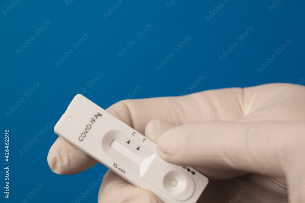 Physician who owns a COVID-19 antigen test kit with a COVID-19 2019 ...