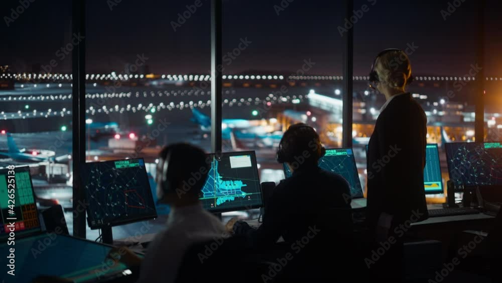 Female and Male Air Traffic Controllers with Headsets Talk in Airport ...