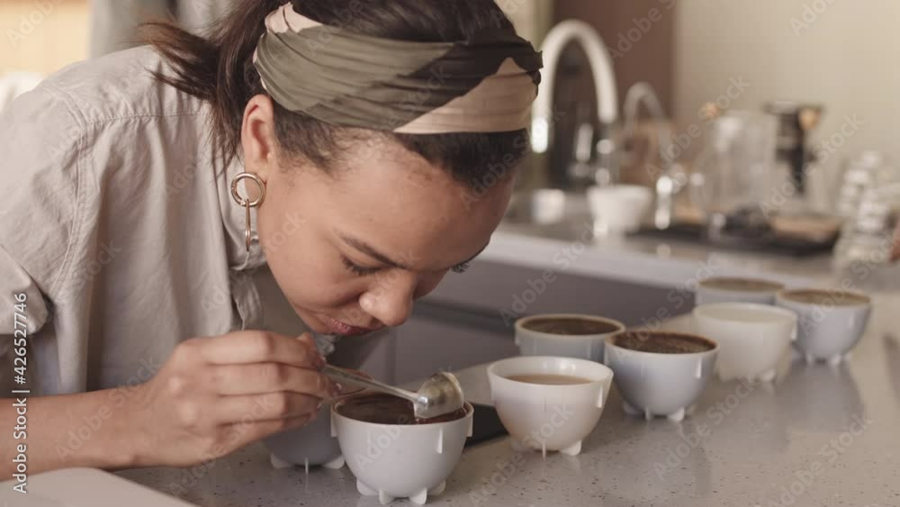 Lockdown of professional female barista tasting different types of ...