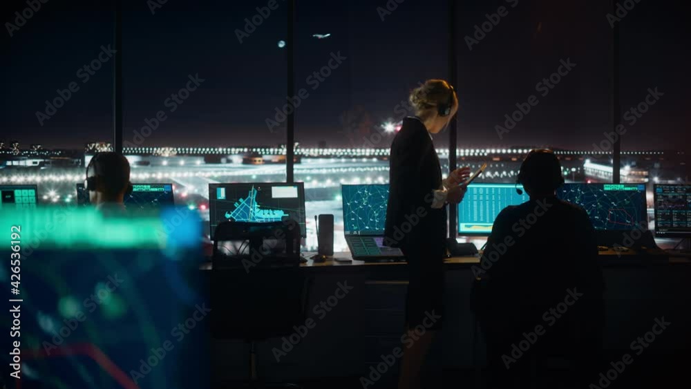 Female and Male Air Traffic Controllers with Headsets Talk in Airport ...