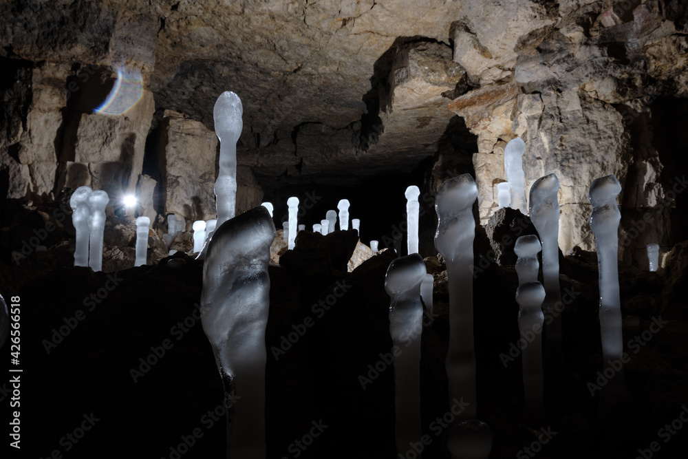 Ice stalactites in an abandoned quarry mine. Travel under the ...