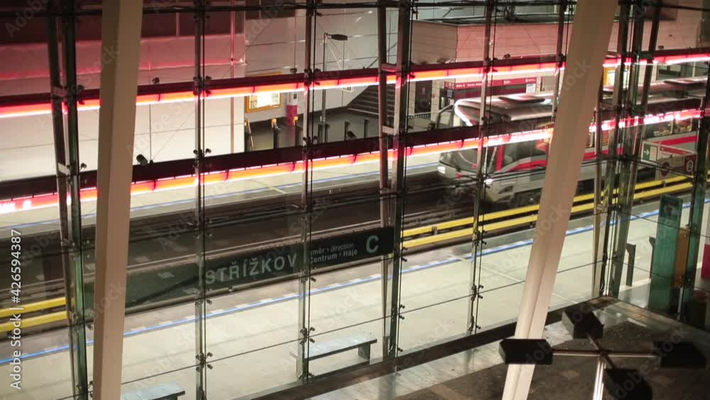 The movement of subway trains at the station. Glass enclosure protects ...