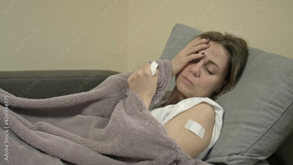 young-woman-lies-on-the-sofa-wrapped-in-a-plaid-she-has-flu-or-cold