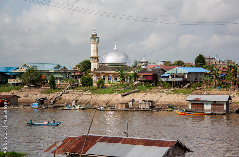 Mahakam River view with a village in the background, floating ...