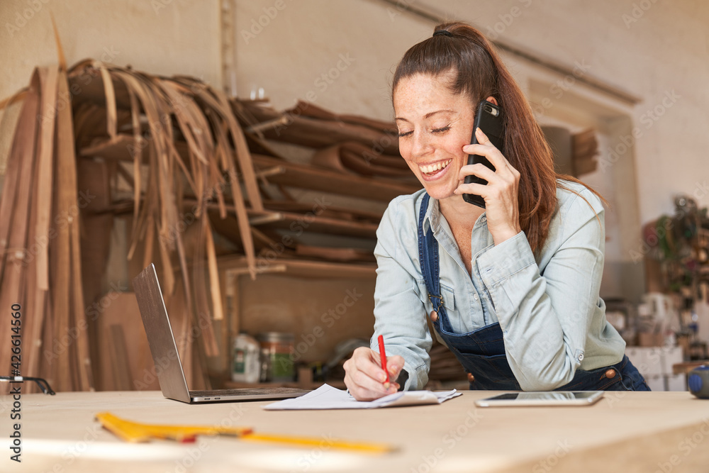 Handyman woman using cell phone in customer service Stock Photo | Adobe ...