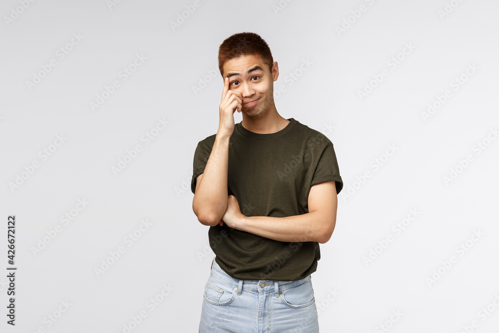 Portrait of bothered and annoyed asian guy hear nonsense, smirk and ... Portrait of bothered and annoyed asian guy hear nonsense, smirk and ...