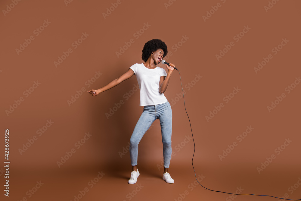 Full body photo of pretty positive dark skin lady hand hold mic singing ...