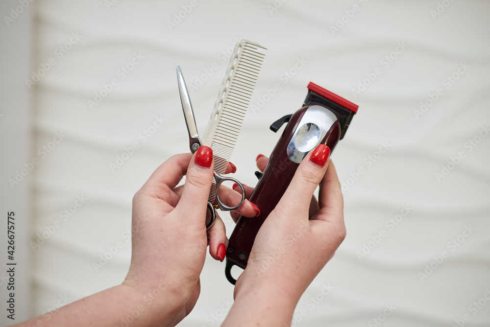 Close-up picture of hairdresser's tools in female hands isolated on ...