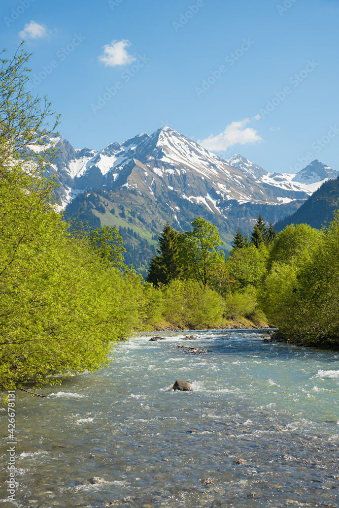 idyllic spring landscape allgau alps, river Stillach and valley ...
