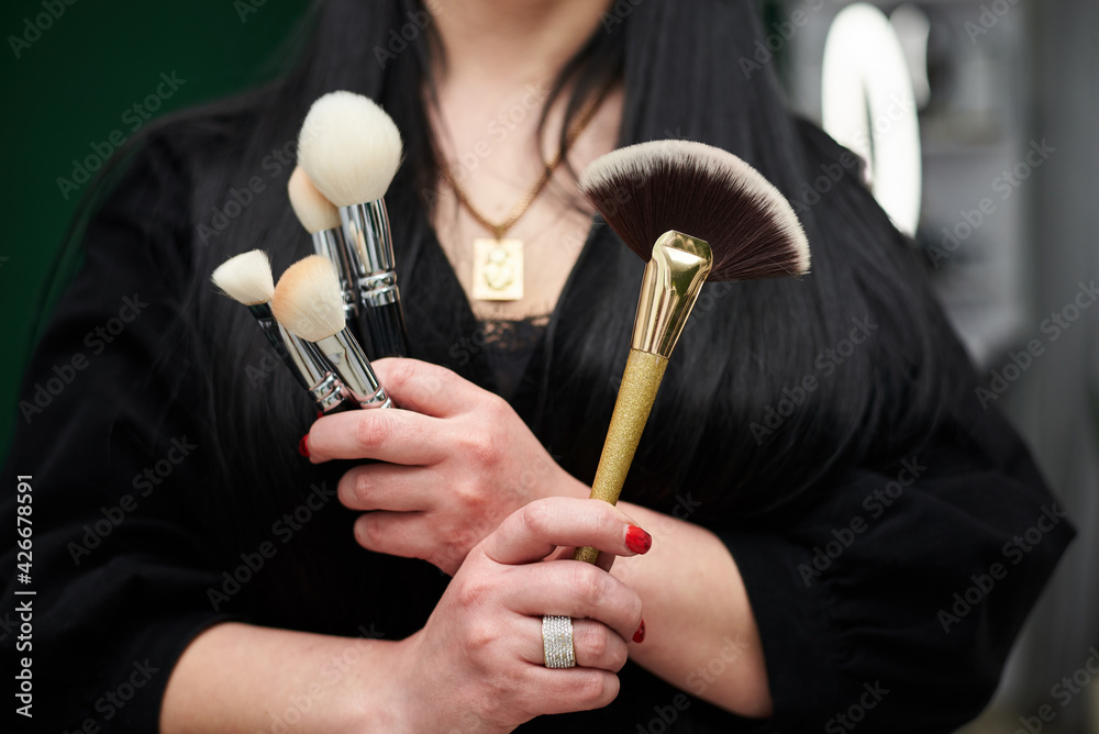 Close-up picture of make-up tools in female hands in beauty salon ...