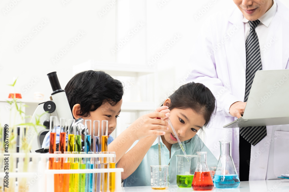 Young Asian boy and girl smile and having fun while doing science ...