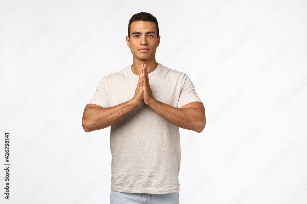 Peaceful Good Looking Strong Athletic Young Man In Casual T Shirt Press Hands Together Over