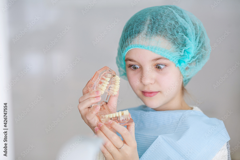 Reception at the dentist, visual aid. The girl holds in her hands an ...