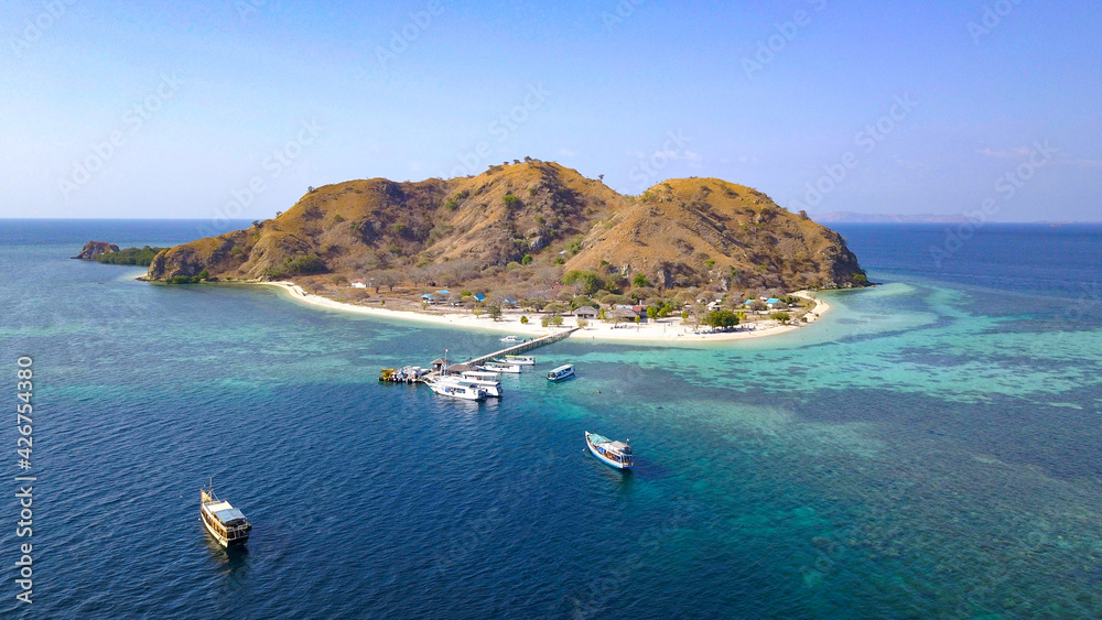 little island with a jetty in labuan bajo, indonesia Stock Photo ...