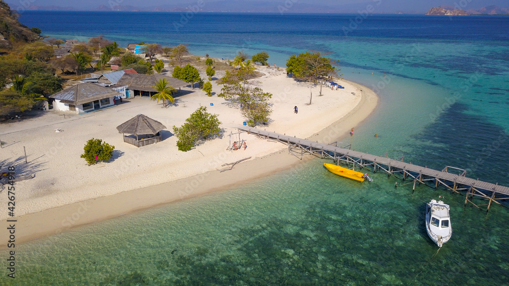 little island with a jetty in labuan bajo, indonesia Stock Photo ...